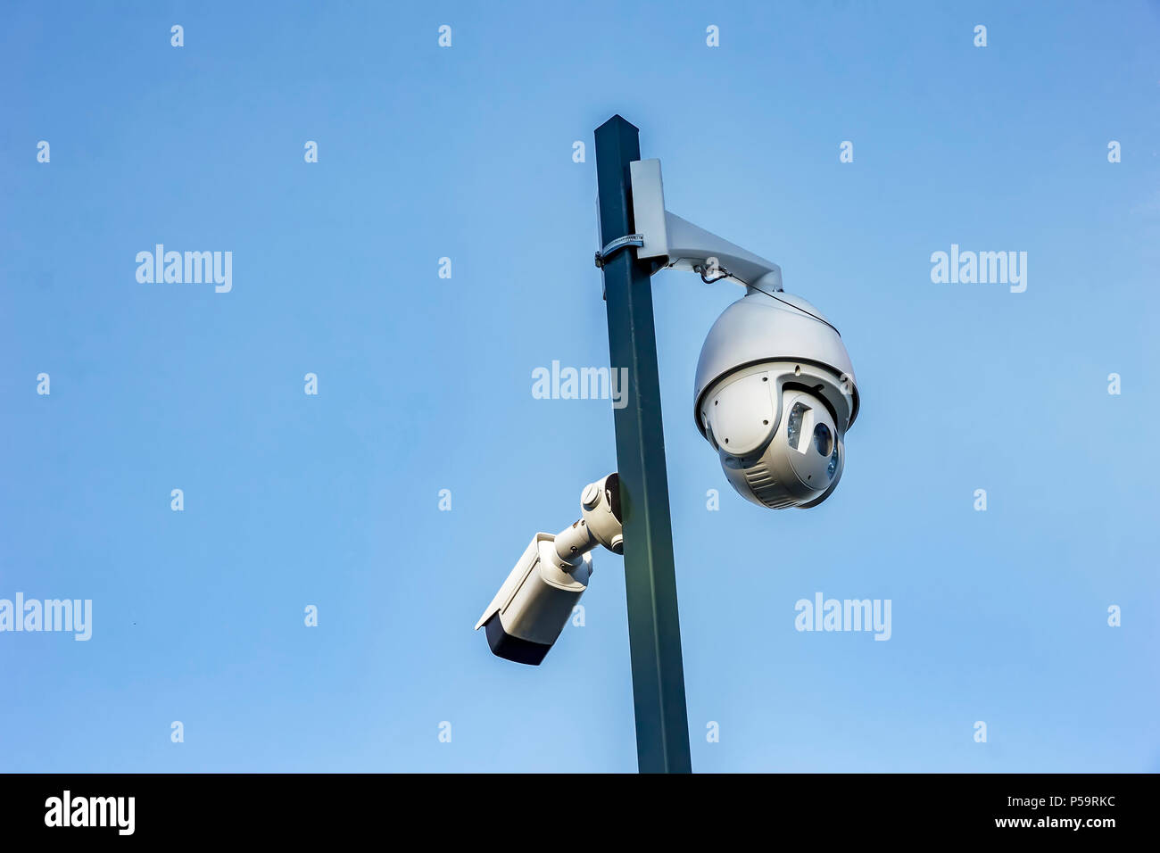 Security cctv cameras on pylon in blue background Stock Photo - Alamy