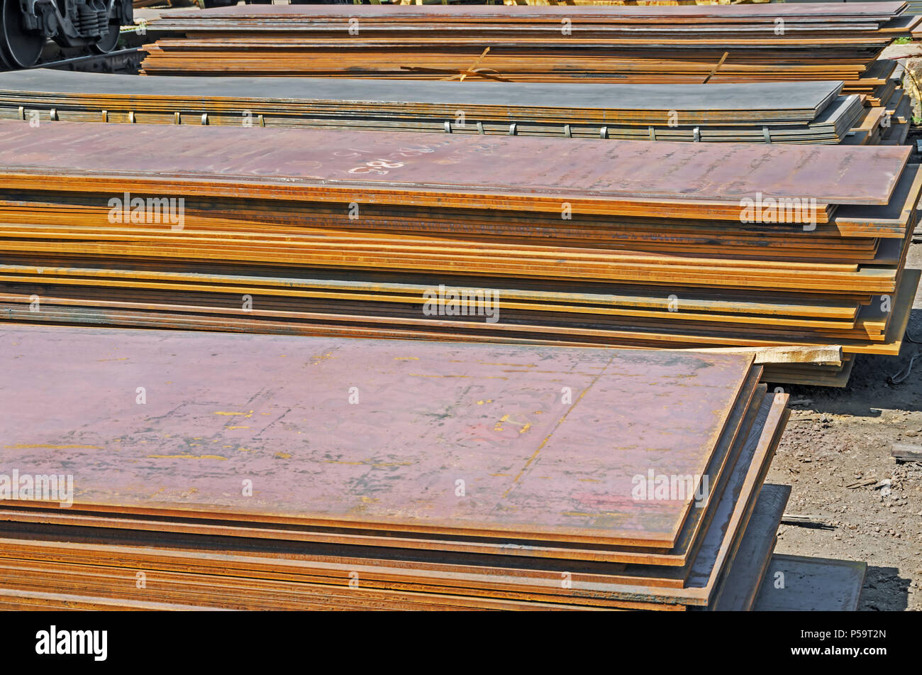 The rusty hot-rolled sheet metal in packs at the warehouse of metal ...