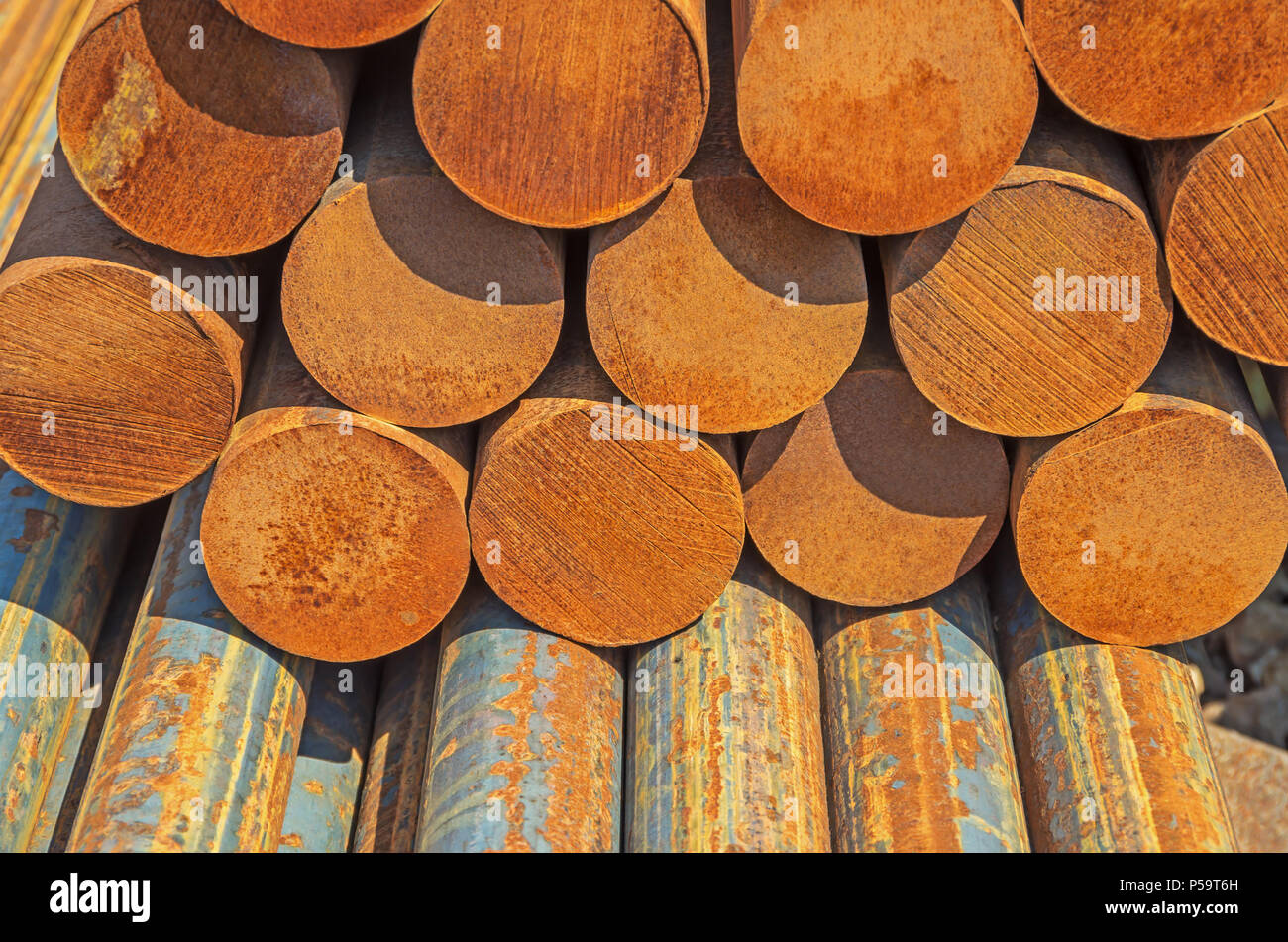 Round steel billets for rolling metal pipes in packs at the warehouse ...