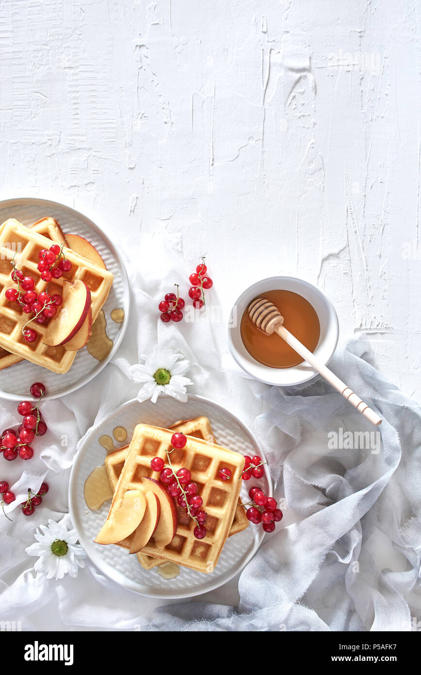 Flat lay of traditional belgian waffles with fresh fruit, nectarine ...