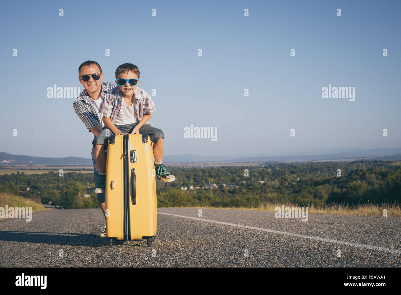 Father and son standing on the road at the day time. Concept of tourism ...
