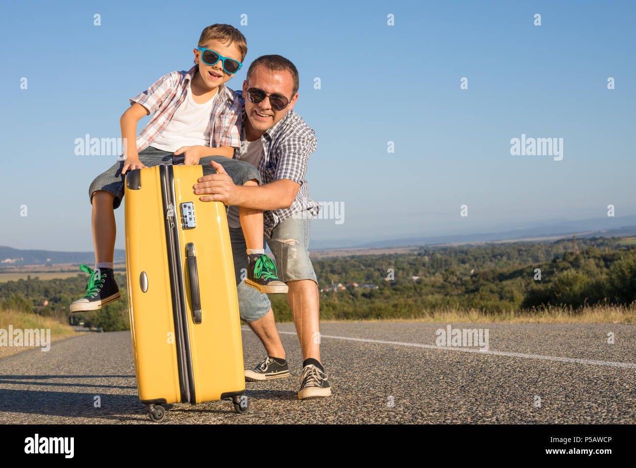 Father and son standing on the road at the day time. Concept of tourism ...