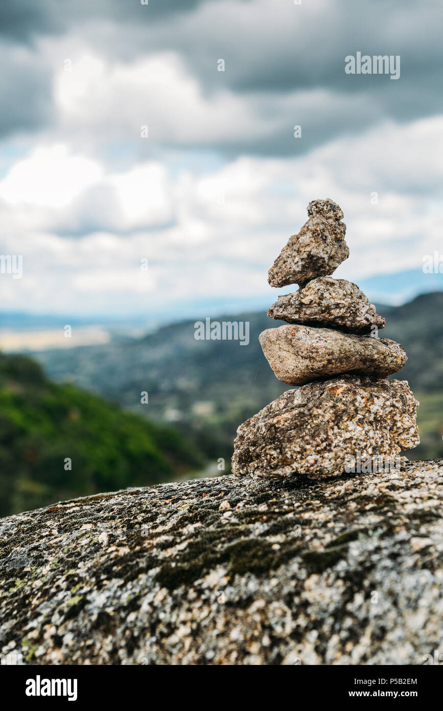 Rock cairn trail marker overlooking a valley in Northeastern Portugal ...