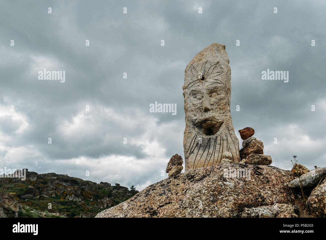 Rock cairn trail marker overlooking a valley in Northeastern Portugal ...