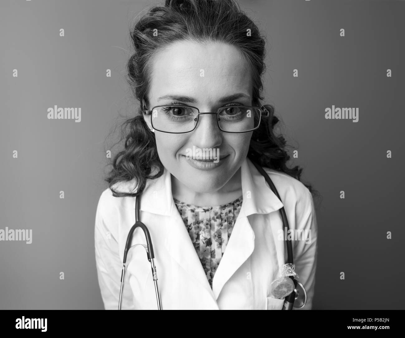 Portrait of pediatrist doctor in white medical robe against background ...