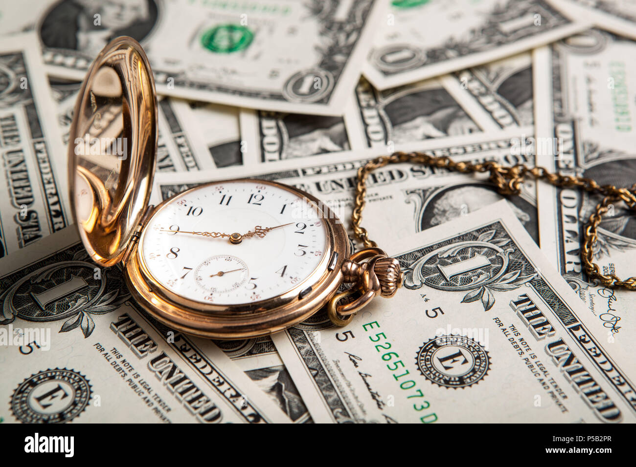 Gold watch dollar bills hi-res stock photography and images - Alamy