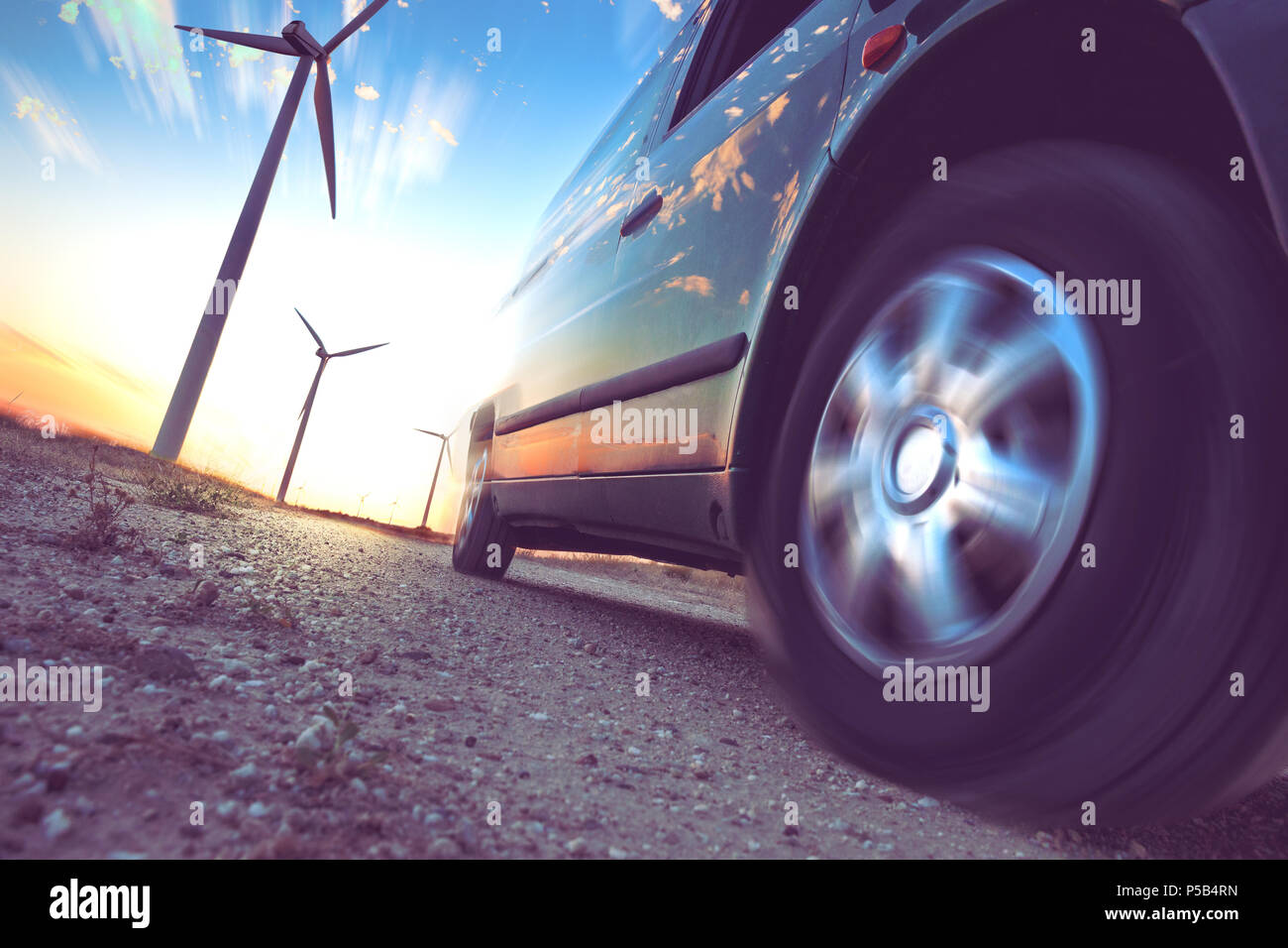 Wind mills and tire car detail.Electricity and ecology Stock Photo - Alamy