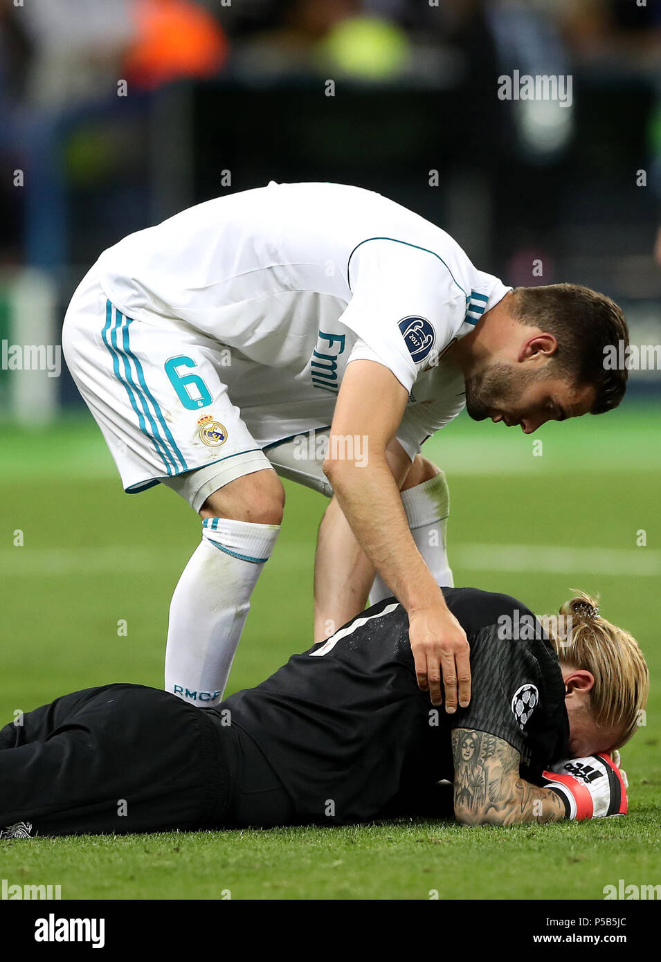 Real Madrid's Fernandez Nacho (left) consoles Liverpool goalkeeper ...