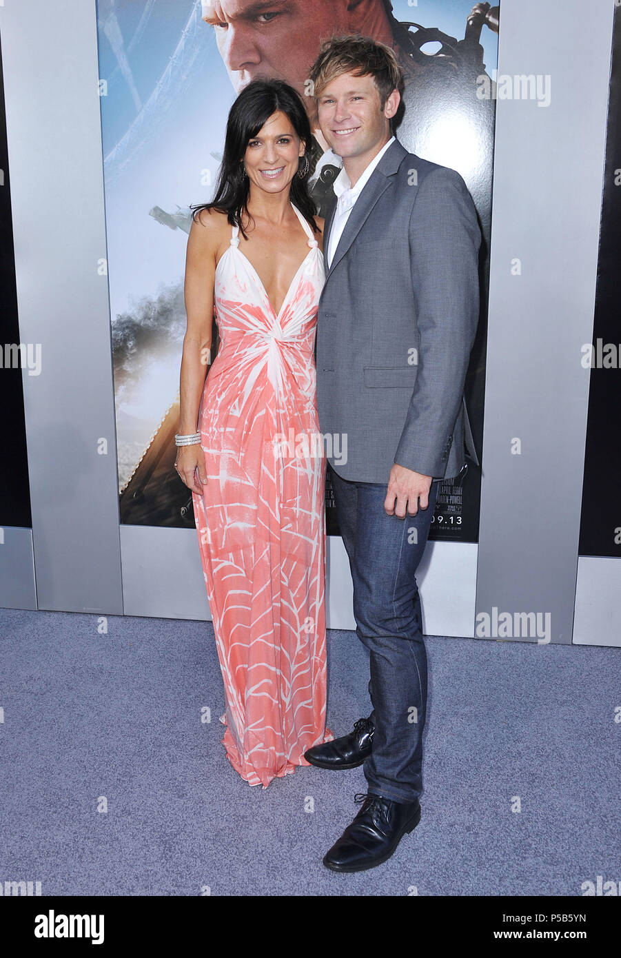 Perrey Reeves and husband arriving Elysium Premiere at the Westwood ...