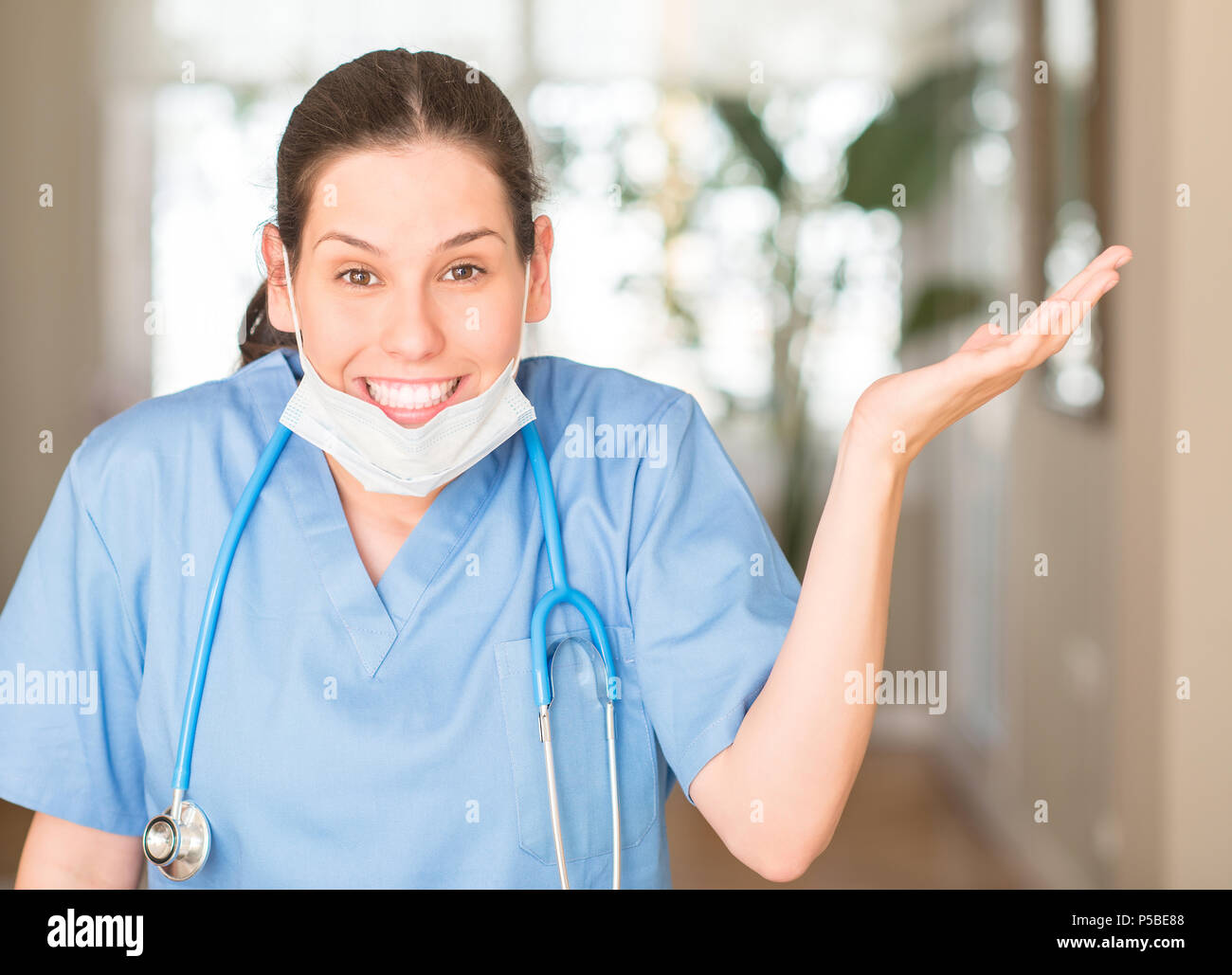 Young nurse woman wearing mask and stethoscope very happy and excited ...