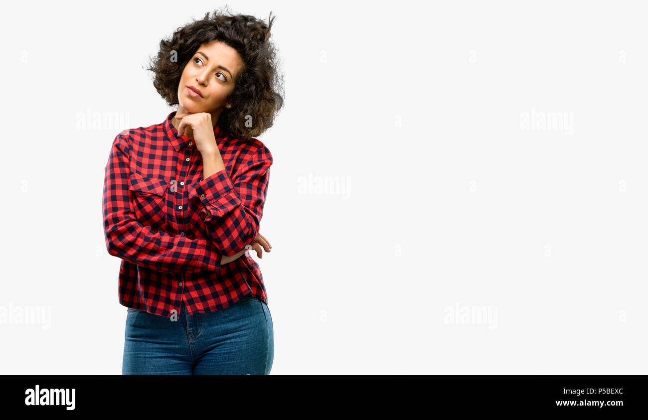 Beautiful arab woman thinking and looking up expressing doubt and ...