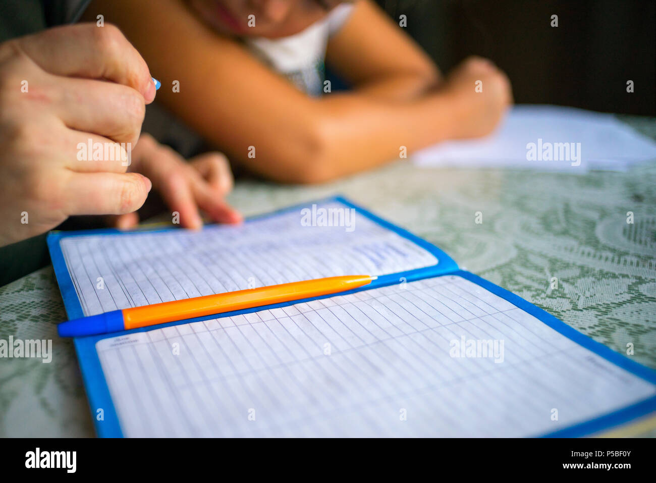 Studing human writing writing in a notebook Stock Photo - Alamy