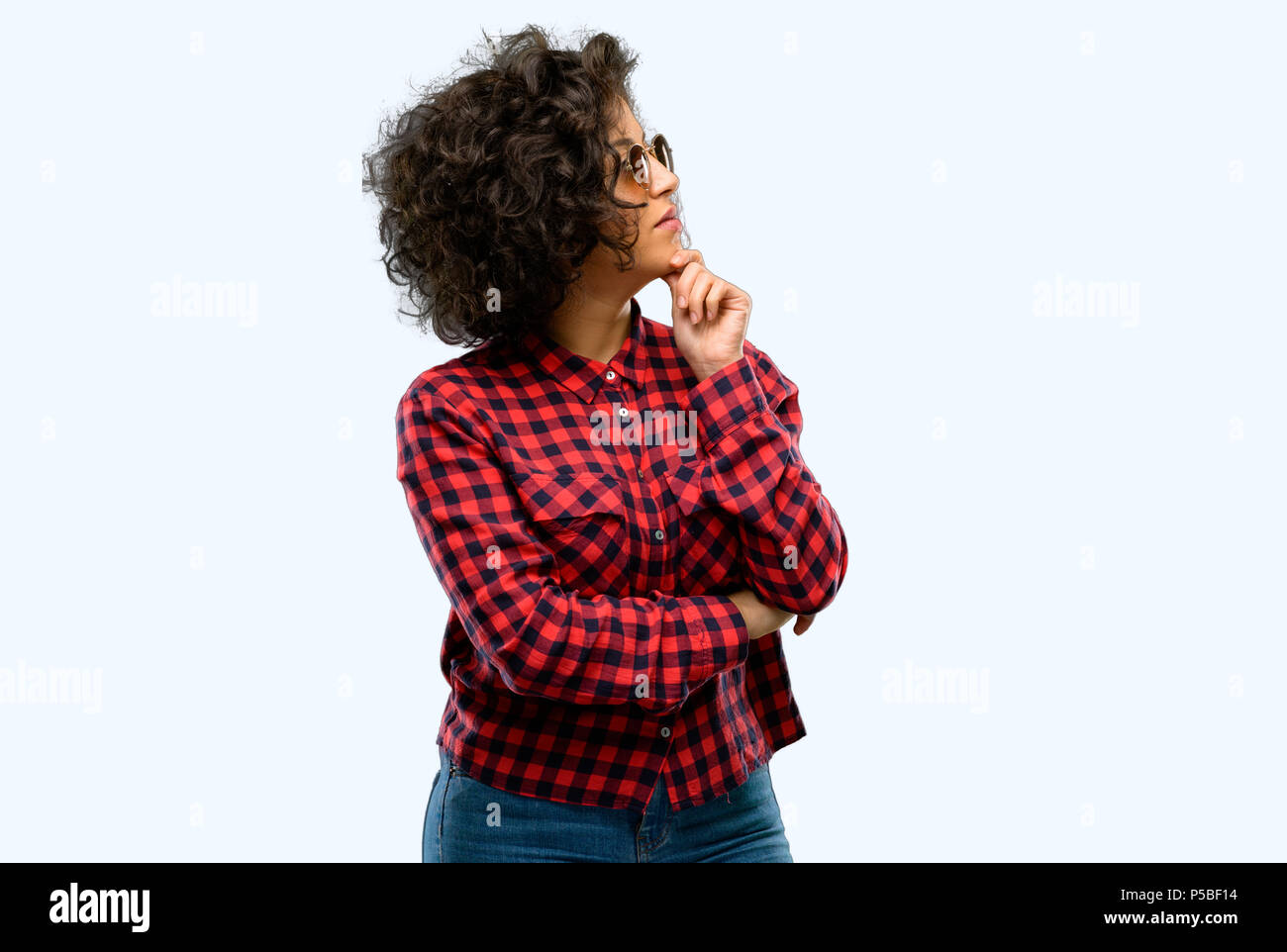 Beautiful arab woman thinking and looking up expressing doubt and ...
