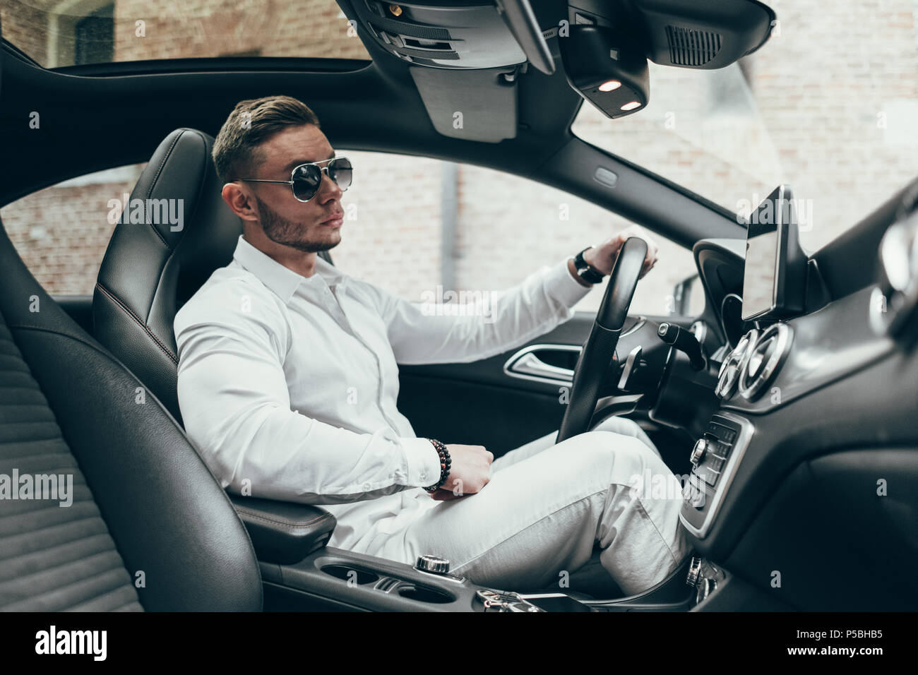 Handsome Young Man Sitting in the Luxury Vehicle Stock Photo - Alamy