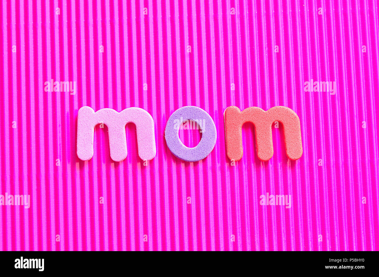 The word mom on a pink background Stock Photo - Alamy