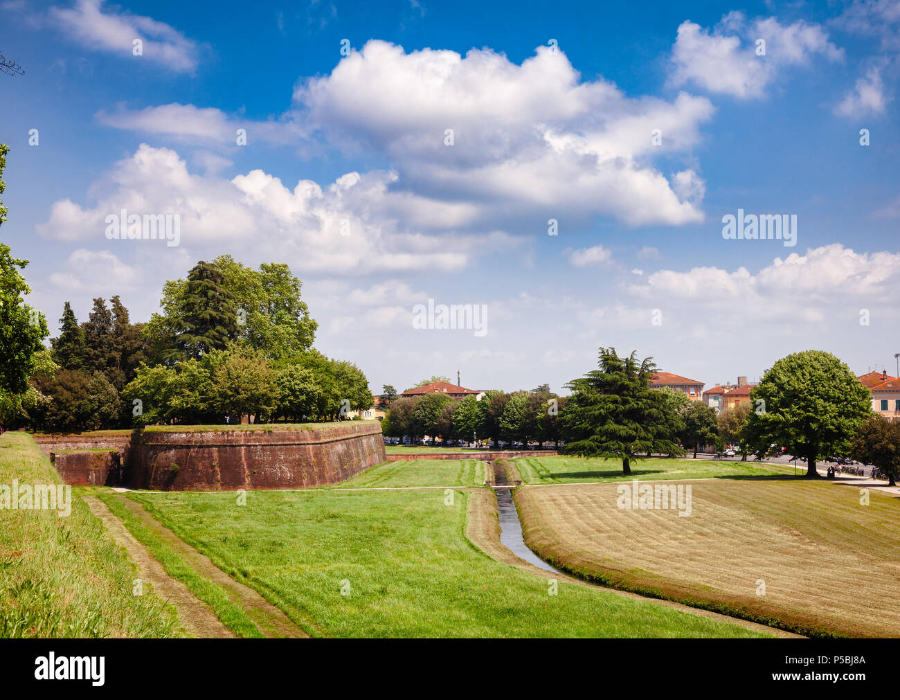 Lucca cityscape with fortified city walls bastion and moat, Tuscany ...
