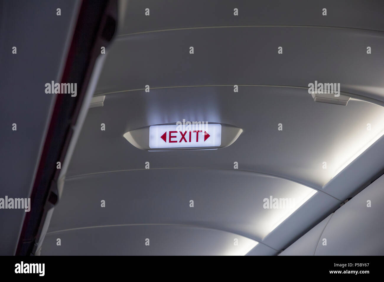 emergency exit sign on the ceiling of airplane Stock Photo - Alamy