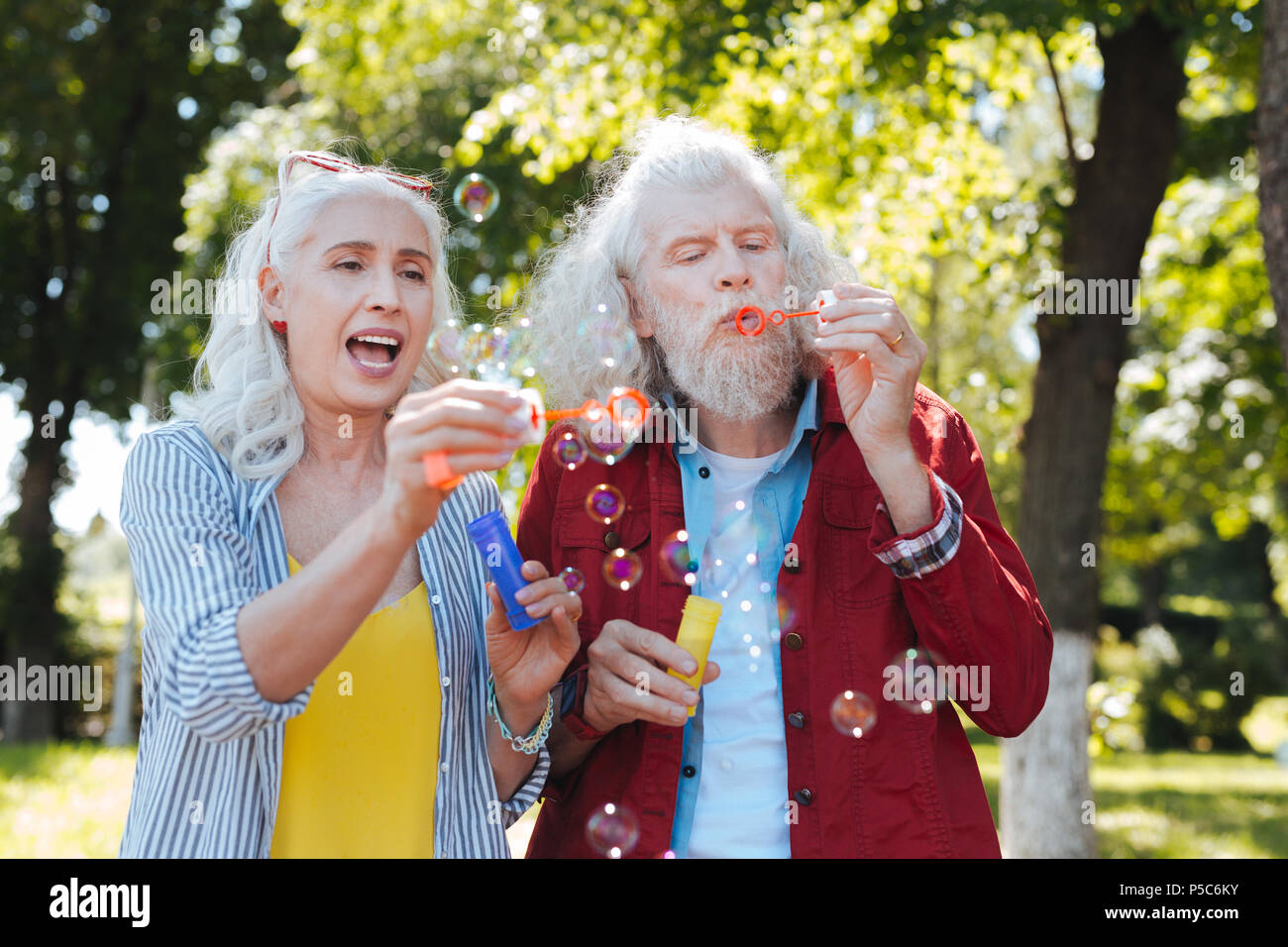 Mature woman blowing bubbles hi-res stock photography and images - Alamy
