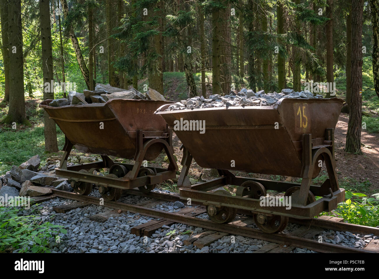 Mining cart with stones. Old and abandoned mining cart in forest Stock ...