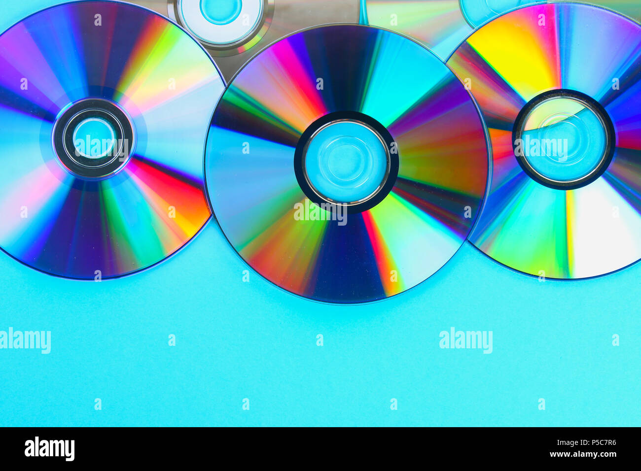 Piles of old and dirty CDs,DVD on pastel background. Used and dusty ...