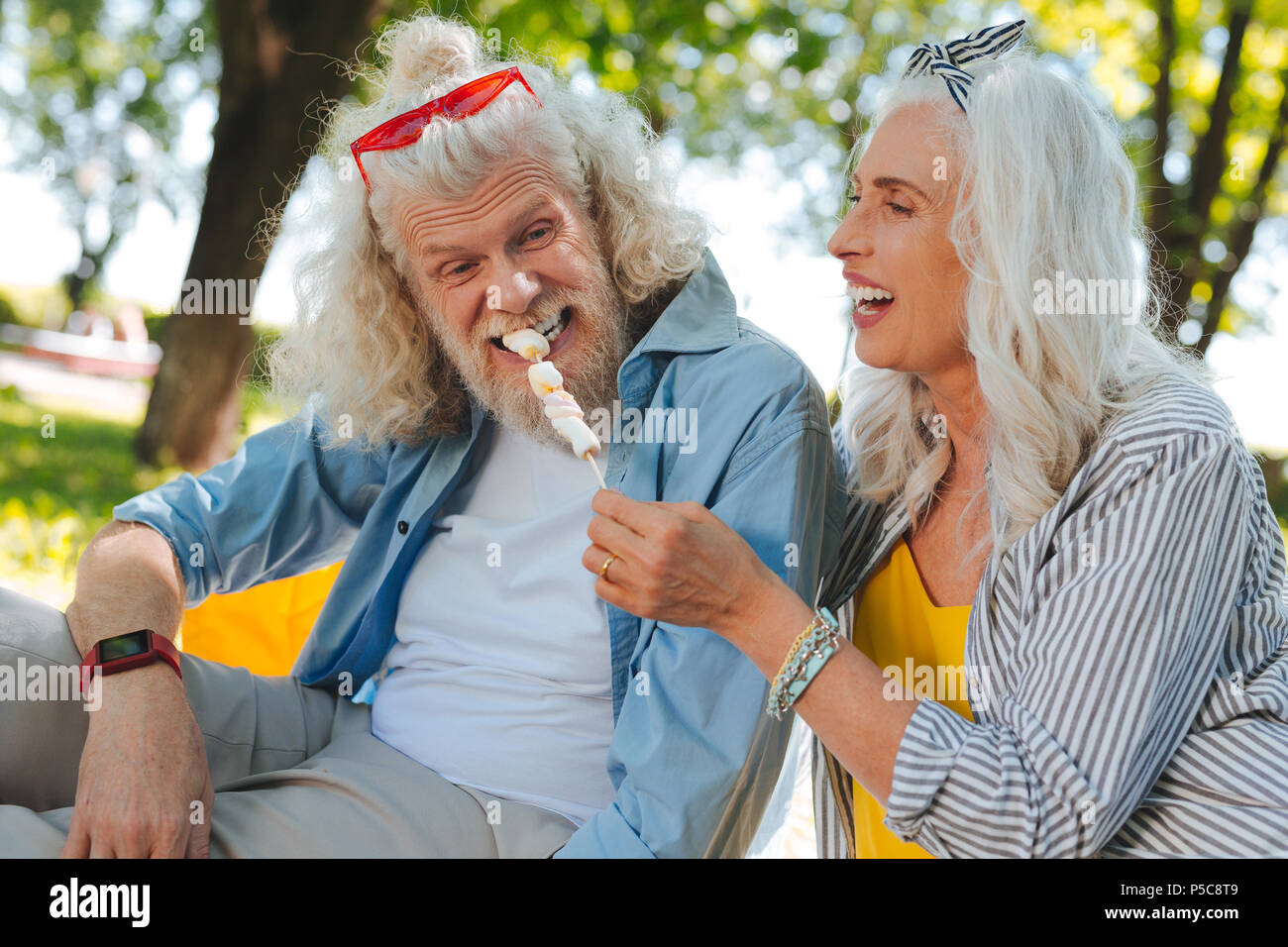 Nice joyful couple eating food Stock Photo - Alamy