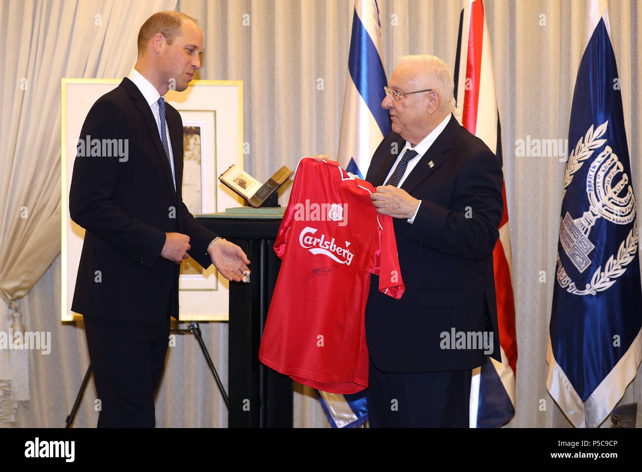 The Duke of Cambridge presents Israeli President Reuven Rivlin with a Liverpool FC shirt, signed ...