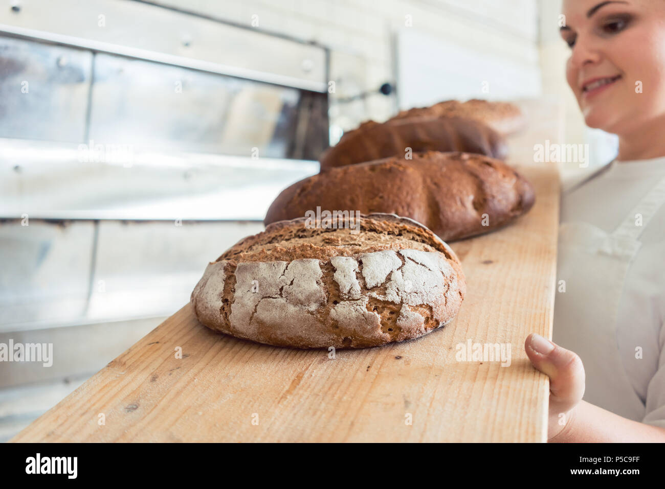 Baker baking bread hi-res stock photography and images - Alamy