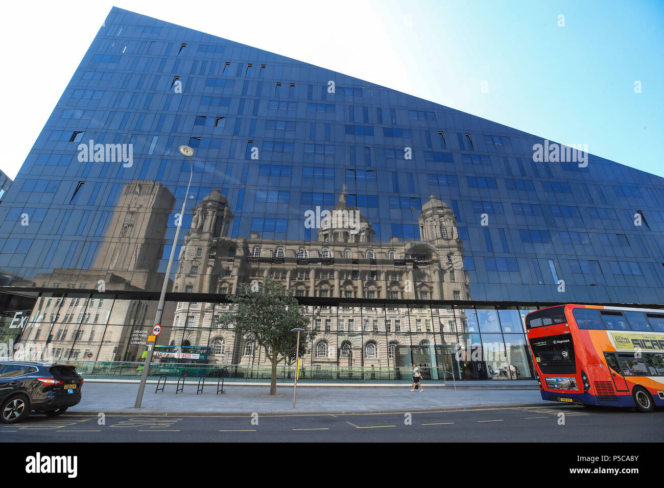 A reflection of the Port of Liverpool Building under blue skies seen in ...