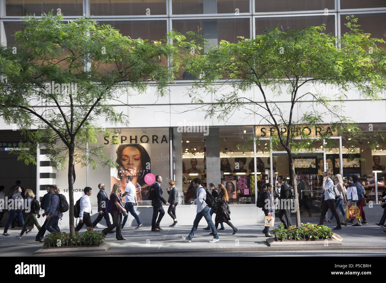 People walk by Sephora on E. 42nd Street with trees on the sidewalk at ...