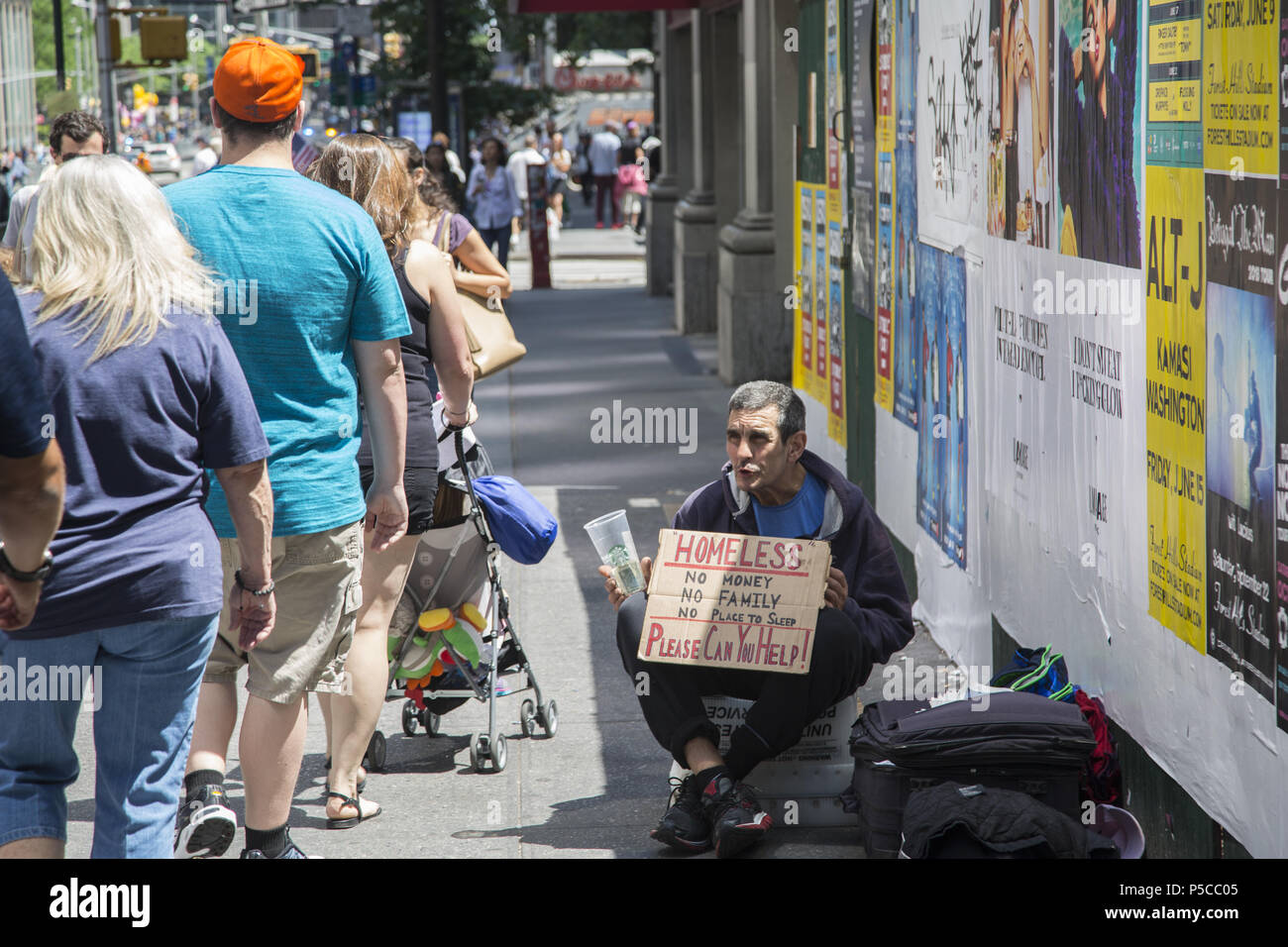Homeless man rfeaches out for help as people pass by on 6th Avenue in ...