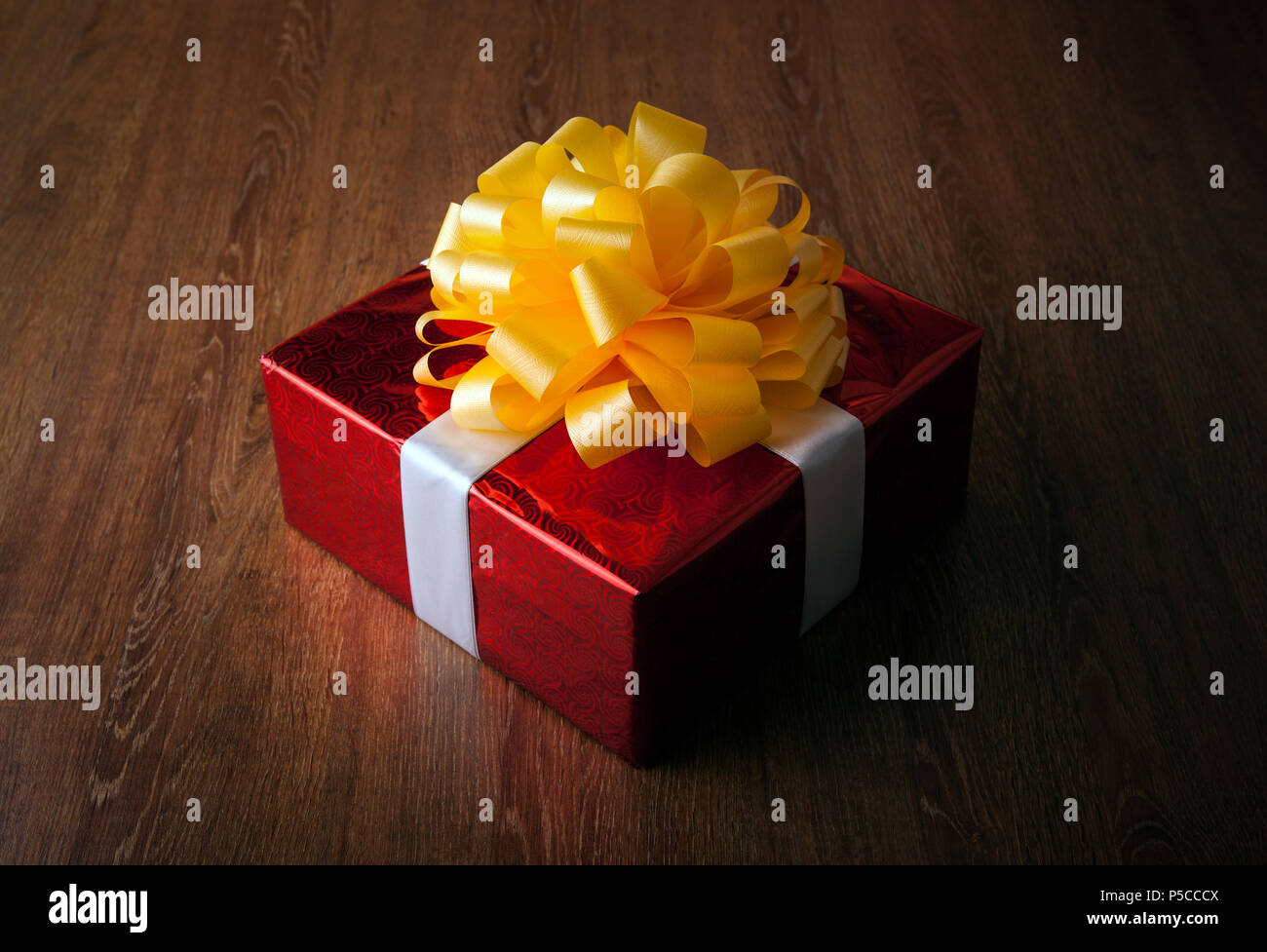 one large red gift box on a wood background Stock Photo - Alamy