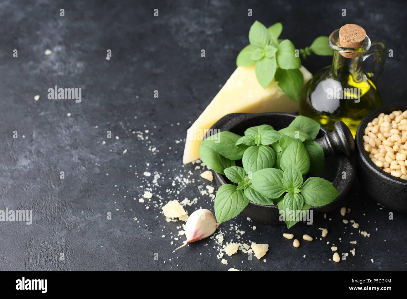 Basil leaves, parmesan cheese and other pesto sauce ingredients on ...