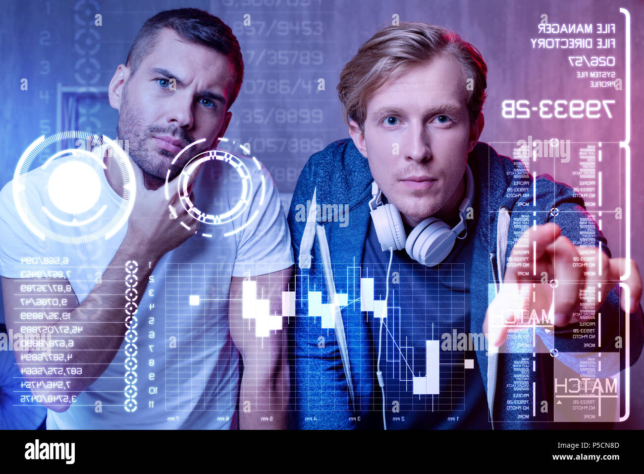 Careful man pointing to the screen and his friend looking interested ...