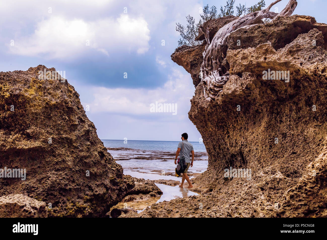 Male tourist at Neil island beach with natural rock formations at ...