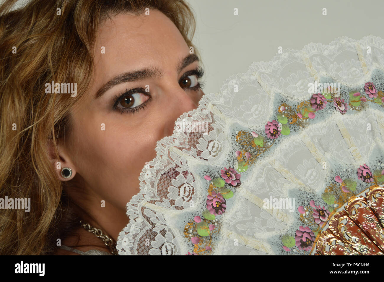 Woman covering face hand fan hi-res stock photography and images - Alamy