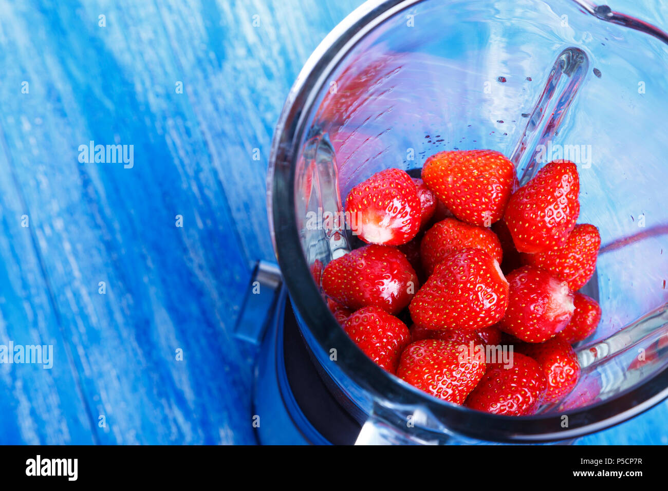 fresh raw strawberries in a blender. cooking strawberry smoothies Stock ...