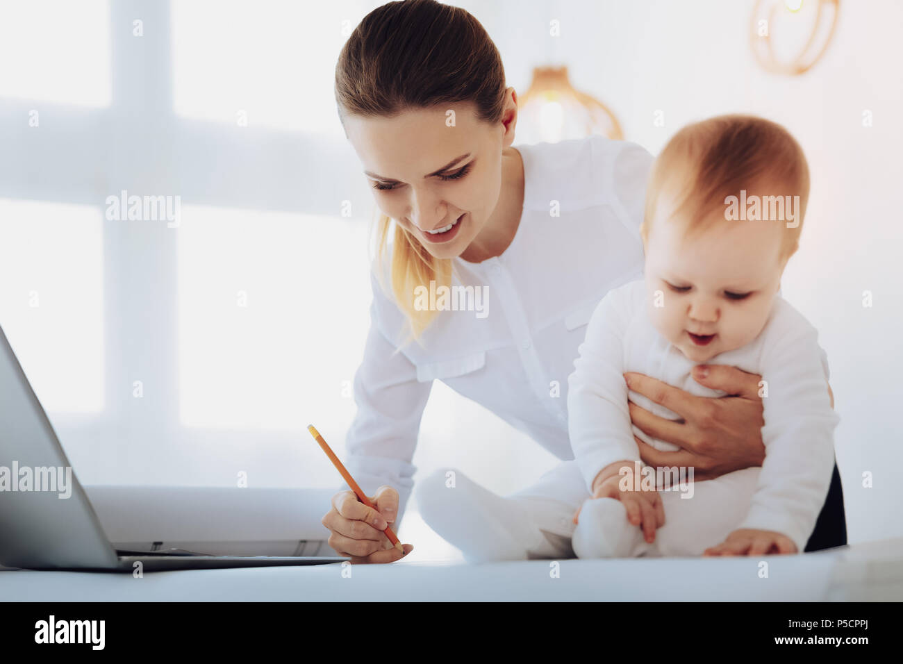 Attentive female person working at project Stock Photo - Alamy
