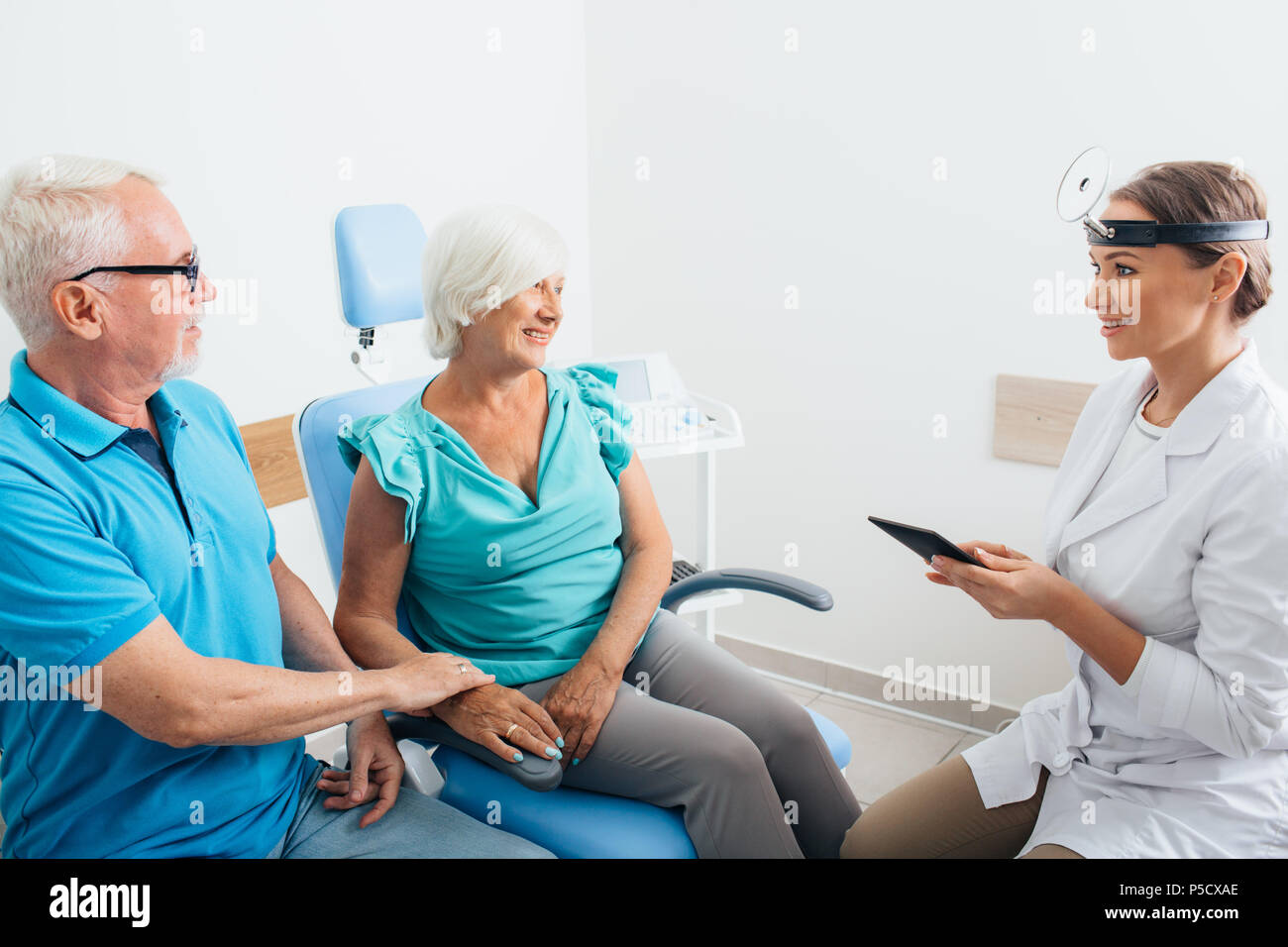 ENT doctor in discussion with mature patients at medical clinic Stock ...