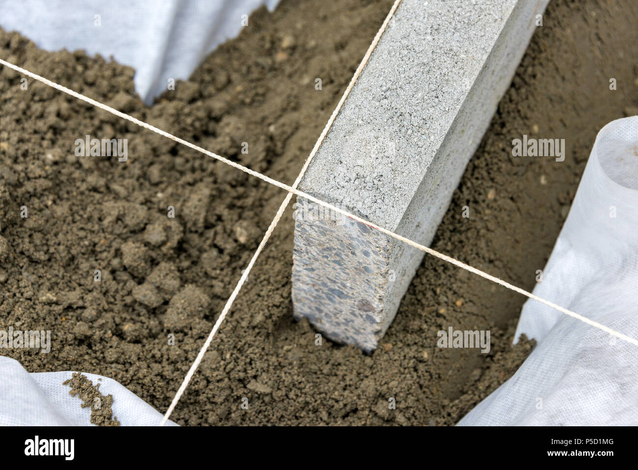 Setting edge restraints buy putting border curb stones in earth-moist ...