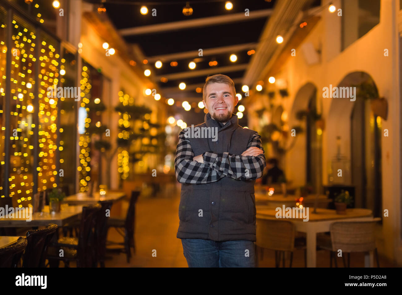 Young smilling guy at night in a cafe Stock Photo - Alamy