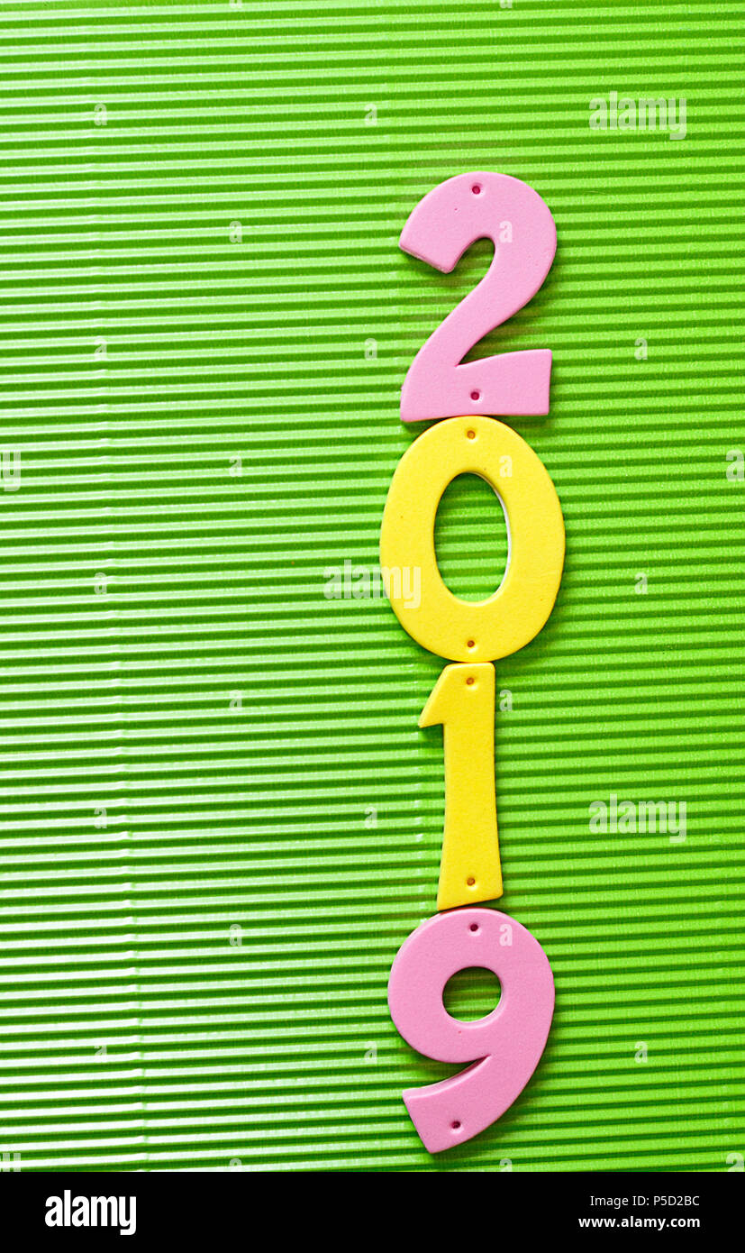 2019 in pink and yellow numbers on a green background Stock Photo - Alamy