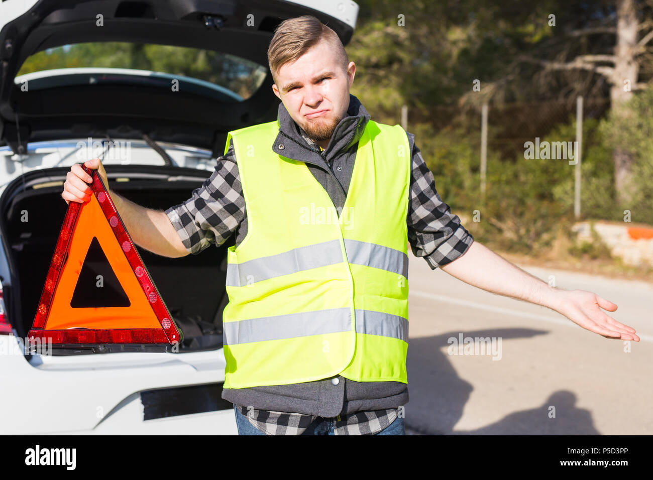 A man with a car gets an emergency sign Stock Photo - Alamy