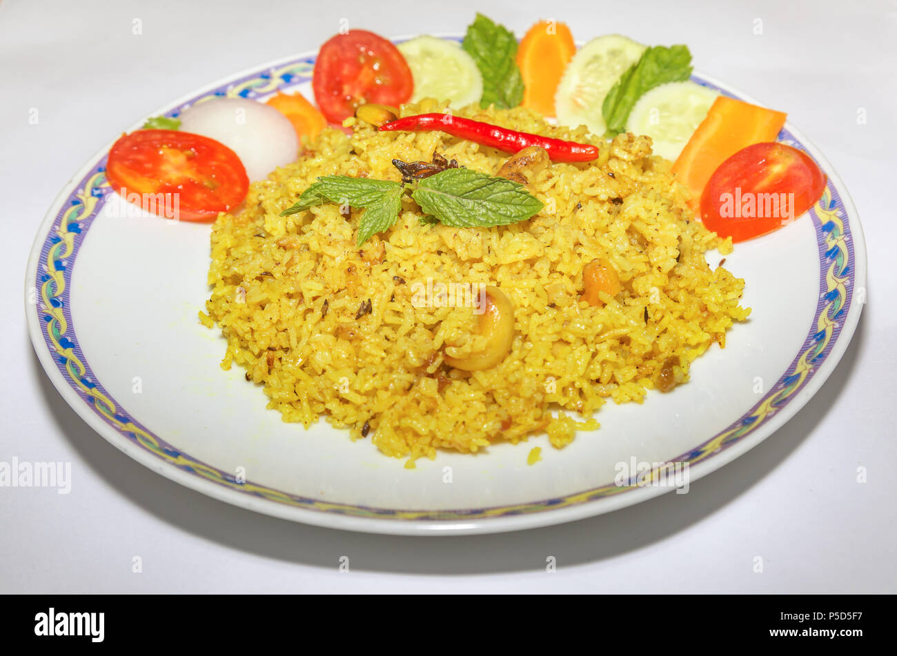 Indian vegetable fried pulao rice with salad isolated on white ...