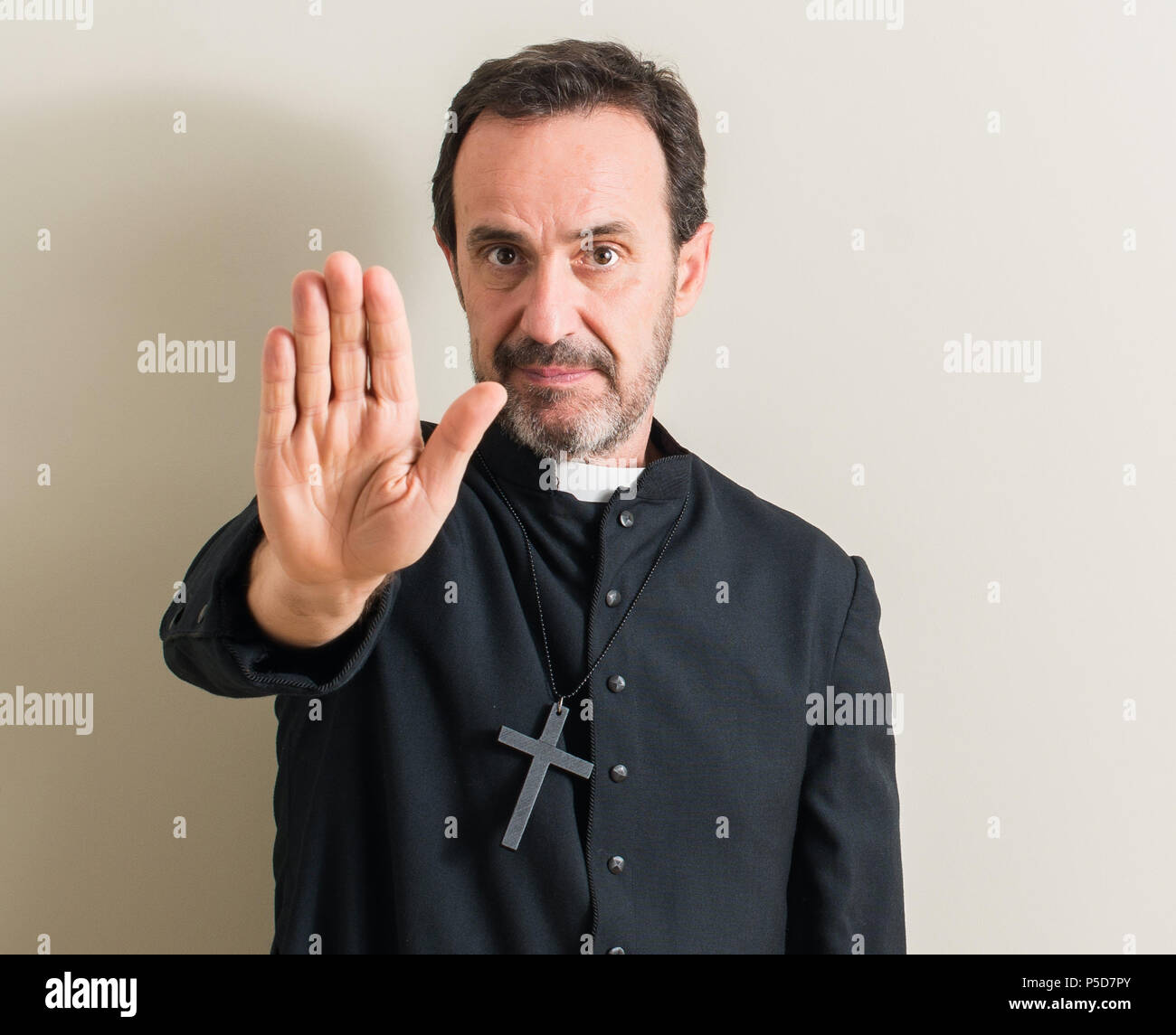 Senior priest religion man with open hand doing stop sign with serious ...