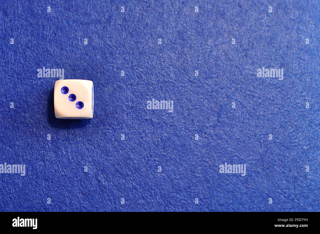 A single dice with the number three displayed on the top Stock Photo ...