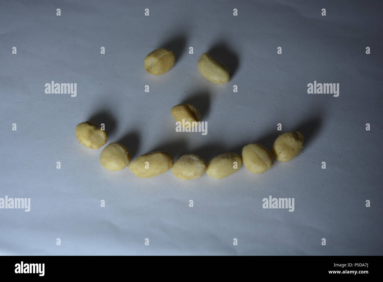 Healthy food, nuts, lots of toasted peanuts placed on a white ...