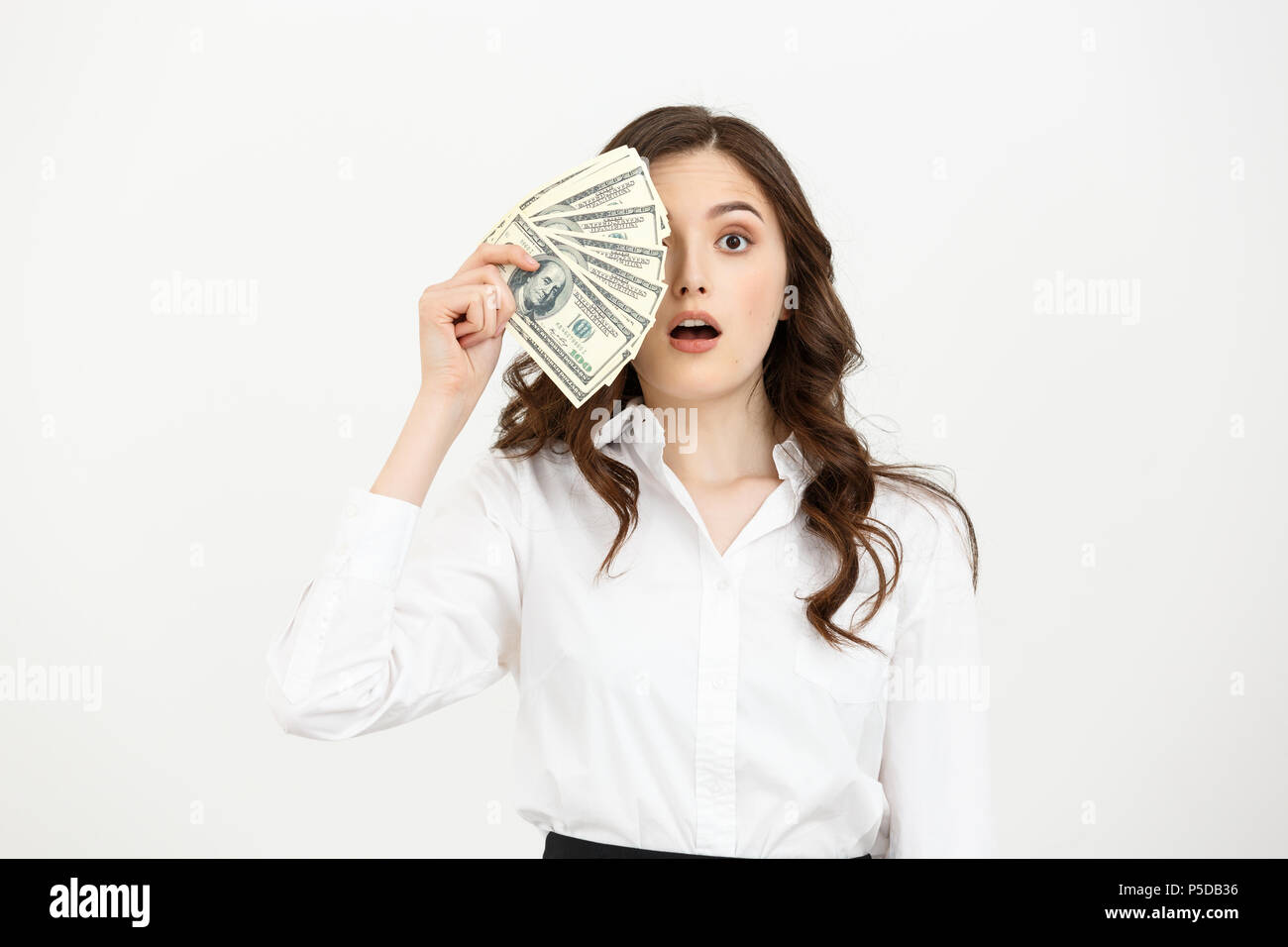 Portrait shocked young business woman standing and holding money ...