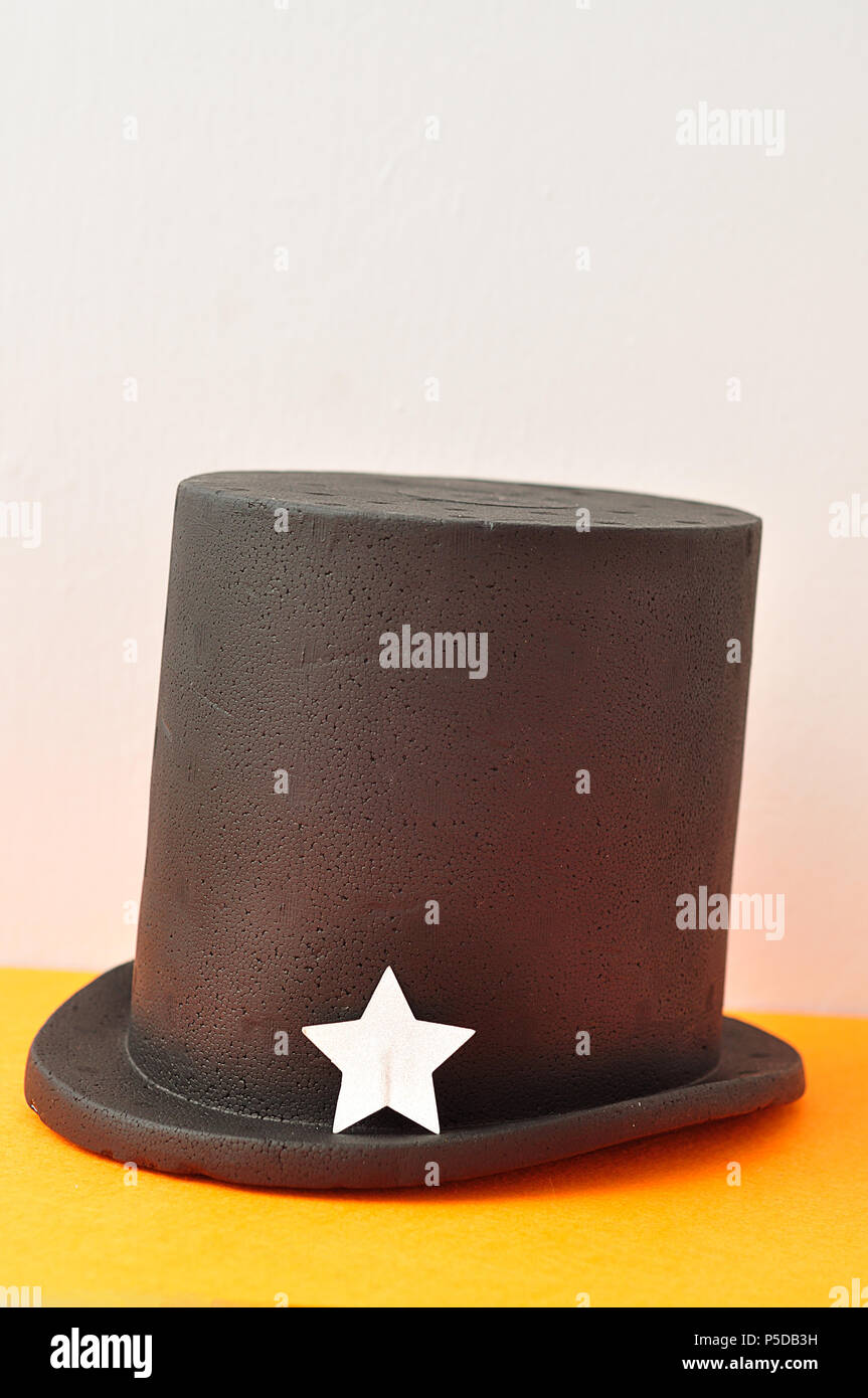 A magicians hat displayed with one silver glitter star Stock Photo - Alamy