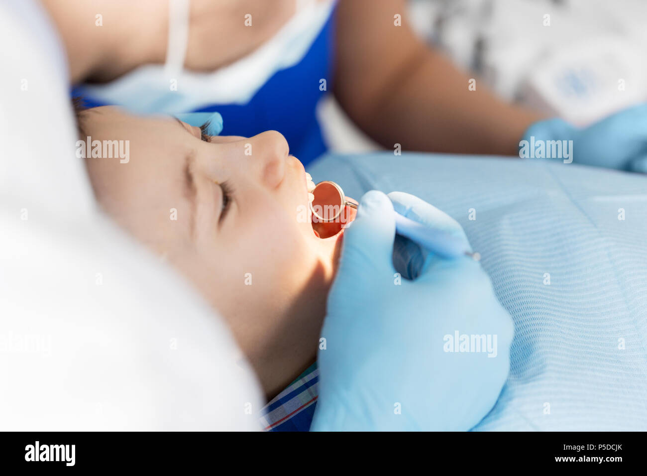 dentist checking for kid teeth at dental clinic Stock Photo - Alamy