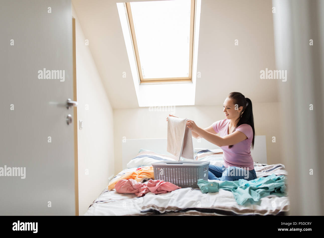 woman or housewife sorting laundry at home Stock Photo - Alamy